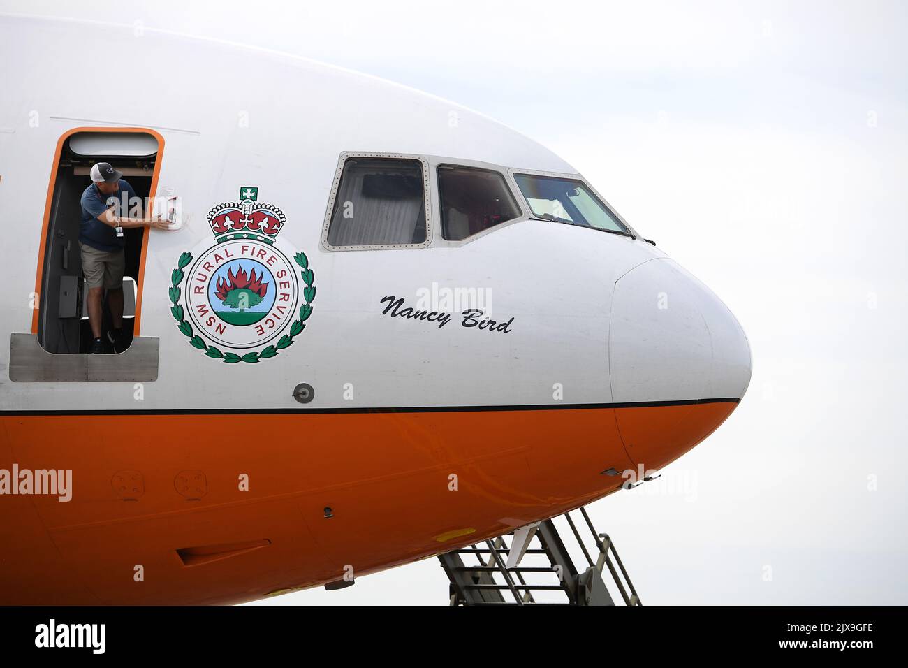 An aircrew member makes final checks on a NSW Rural Fire Service Very ...