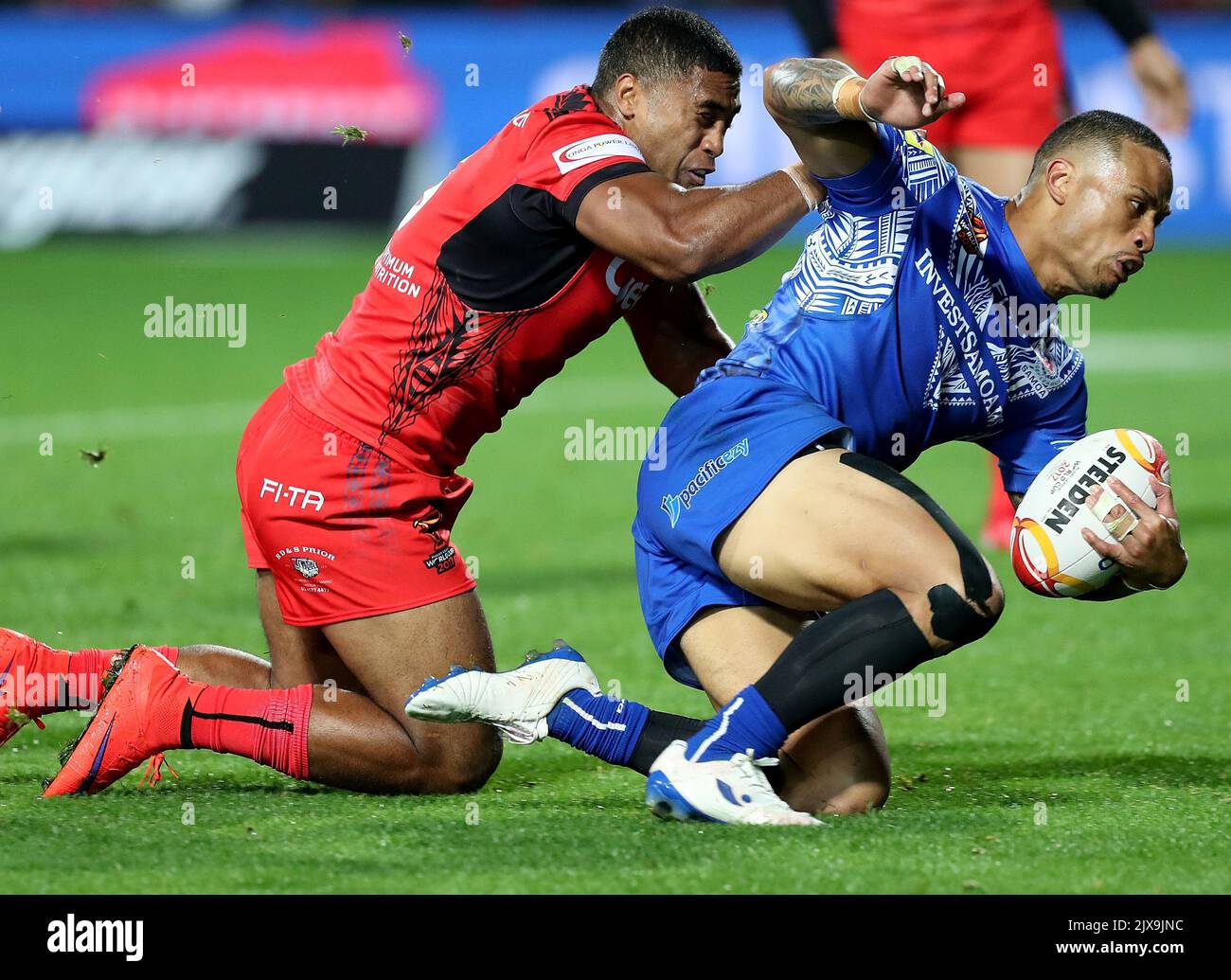 Ben Roberts of Samoa beats Michael Jennings of Tonga to score a try ...