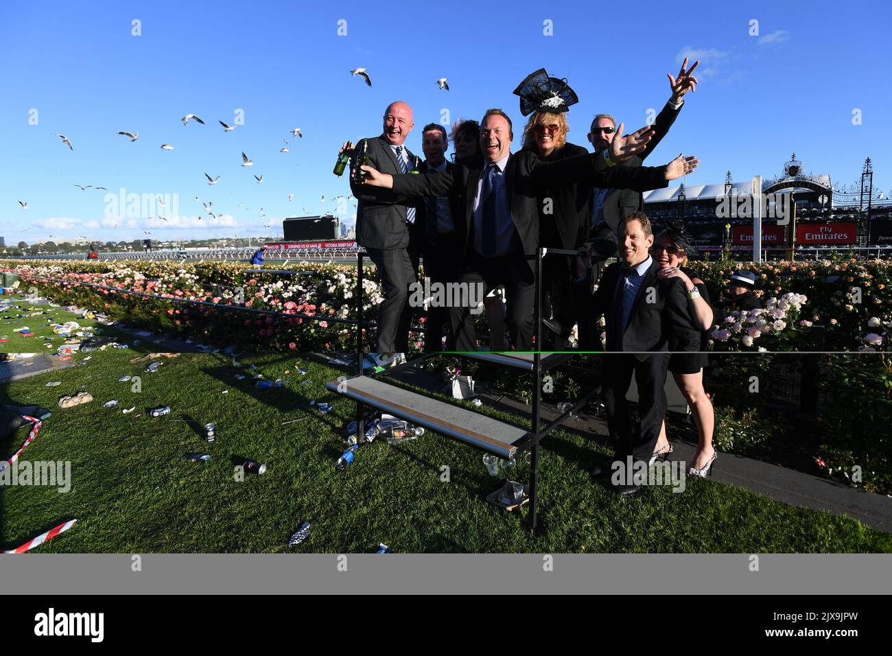 Racegoers pose for a photograph at the conclusion of Victoria Derby Day ...