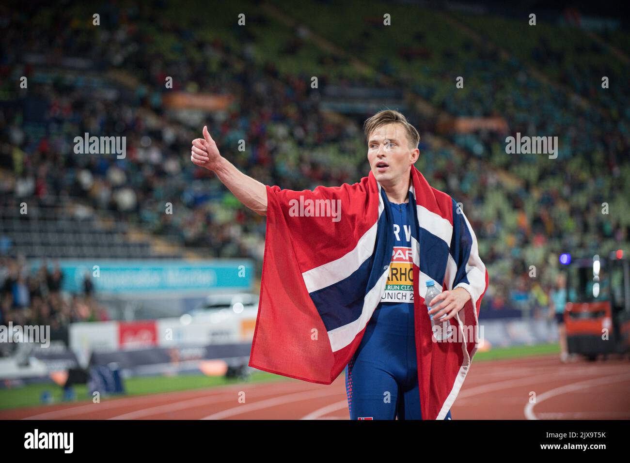 Karsten Warholm with her country's flag as the winner of the 400 meters ...