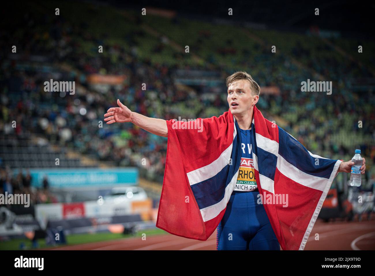 Karsten Warholm with her country's flag as the winner of the 400 meters ...
