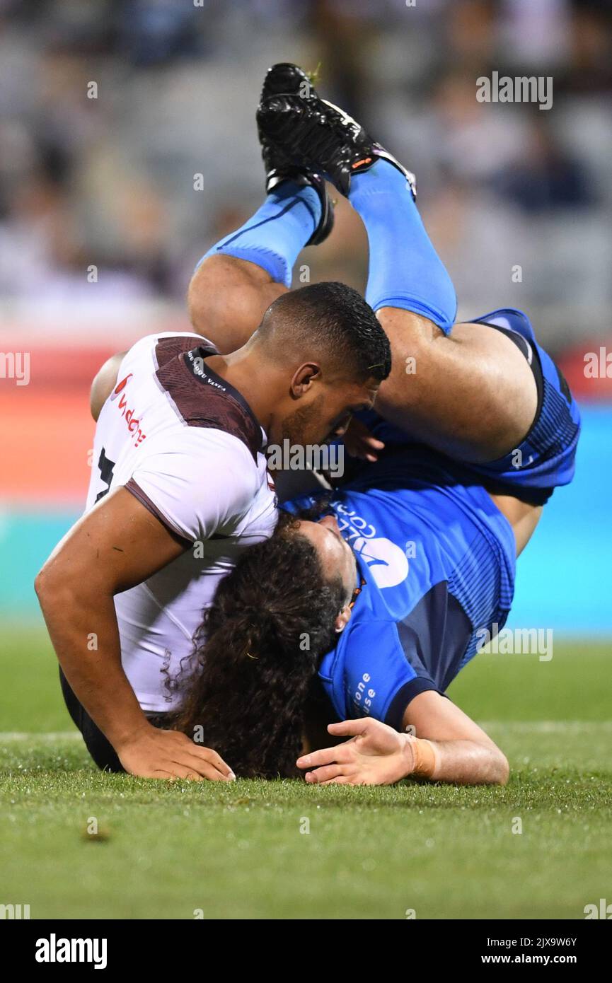 Taane Milne of Fiji (left) tackles Brendan Santi of Italy during the ...