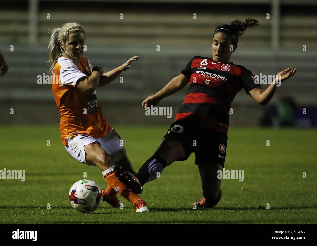 Roar Amy Chapman fights for the ball against Wanderers Lee Falkon ...