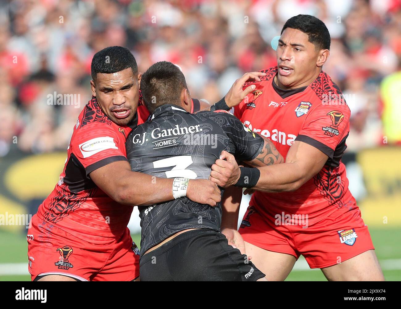 Siliva Havili (left) and Jason Taumalolo of Tonga tackle Dean Whare of ...