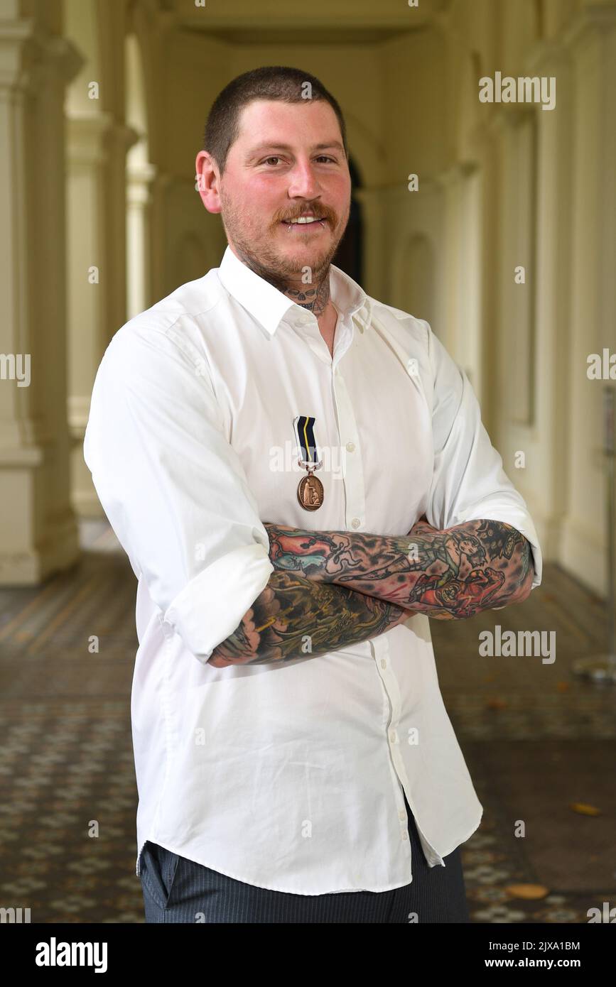 Nathan Beasy, recipient of a bronze bravery award, poses for a ...