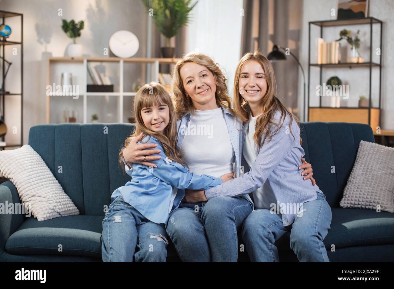 Portrait of happy mother hugging two little kids. Joyful affectionate ...