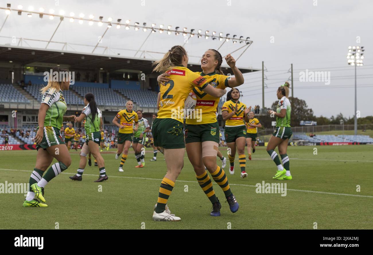 Karina Brown of Australia (right) celebrates after scoring a try during ...