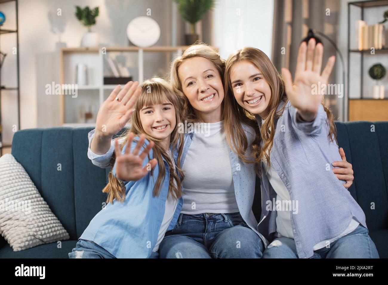 Happy mom and two little sibling kids enjoying leisure at home together ...