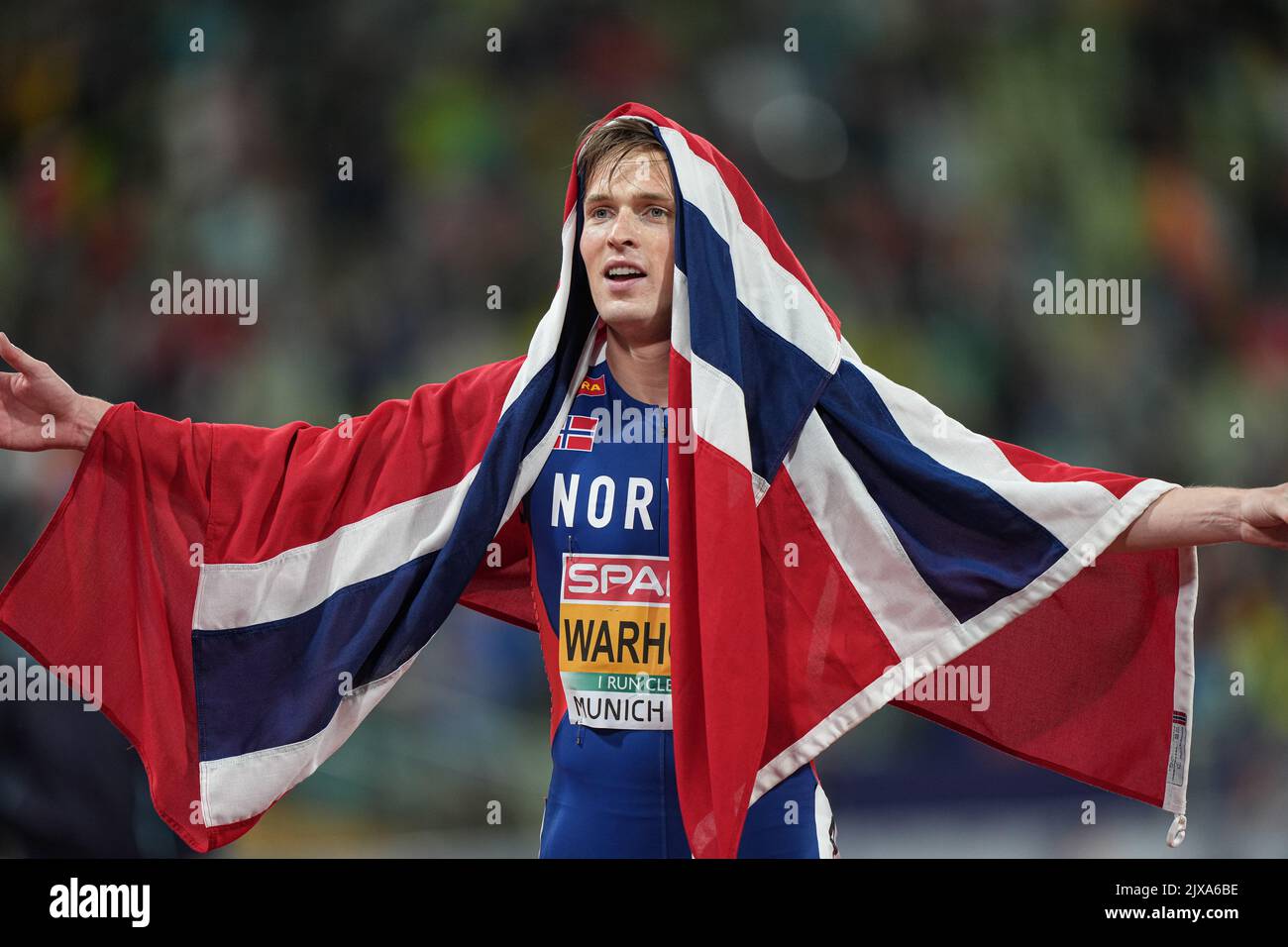 Karsten Warholm with her country's flag as the winner of the 400 meters ...