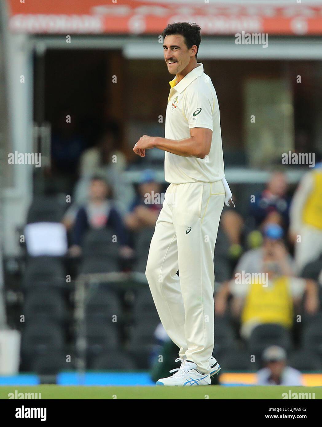 Australian bowler Mitchell Starc smiles on Day 1 of the First Test ...