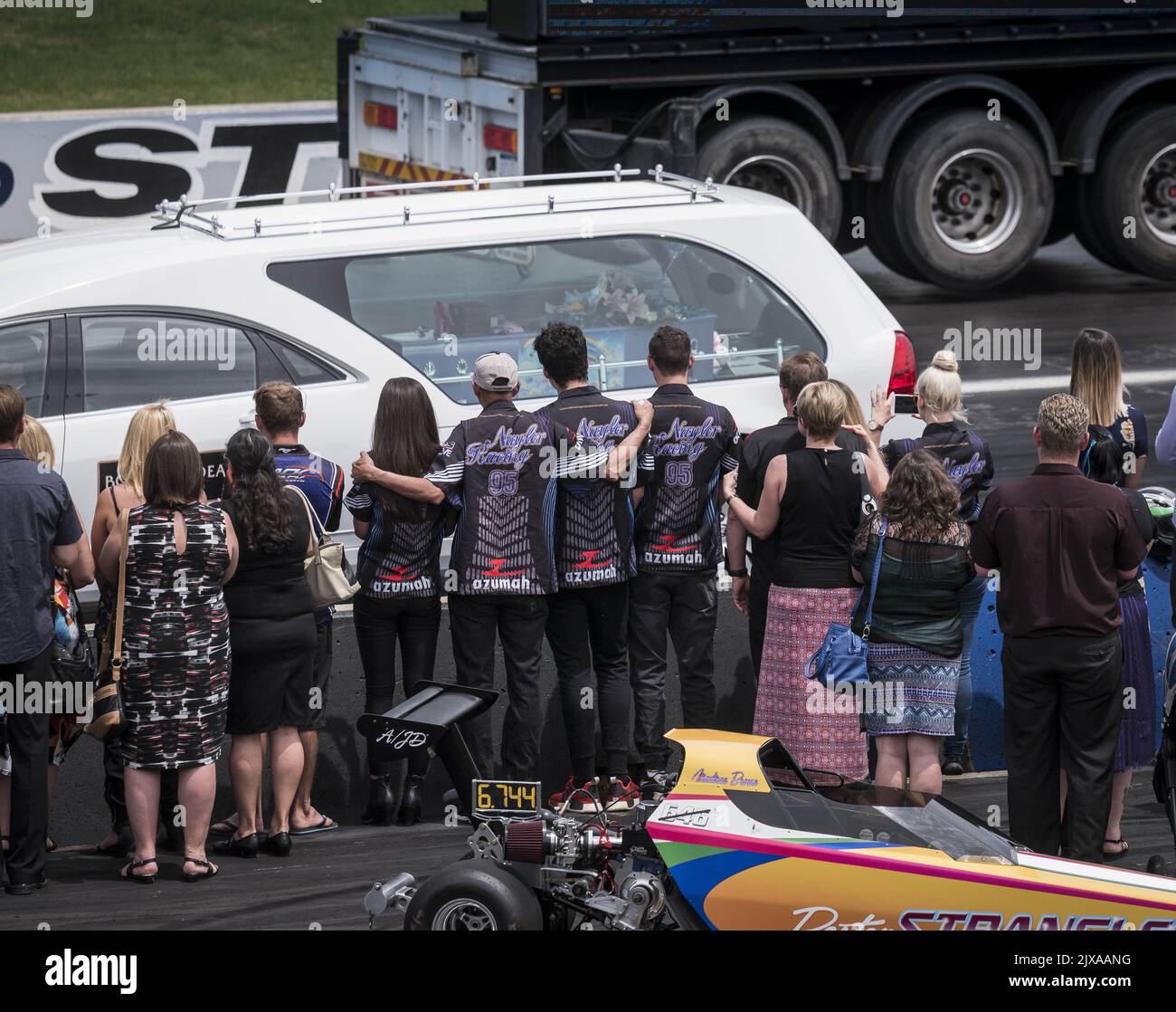 Morners watch the hearse carrying Anita's coffin make a trip down the ...