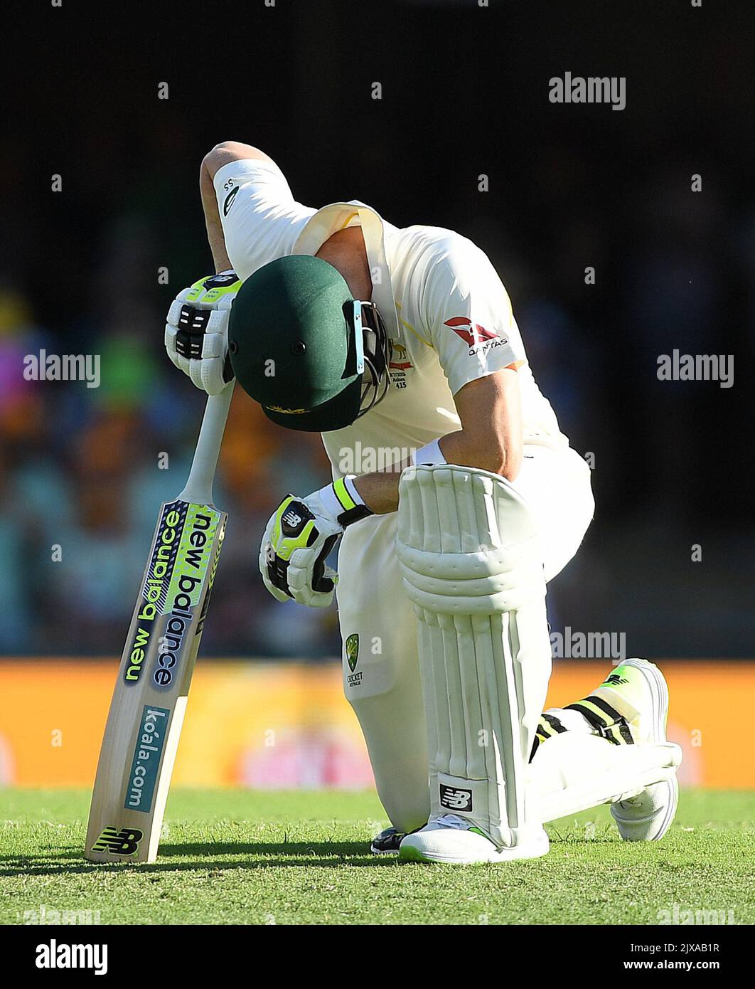 Australian batsman Steve Smith recovers after being hit by the bowling ...