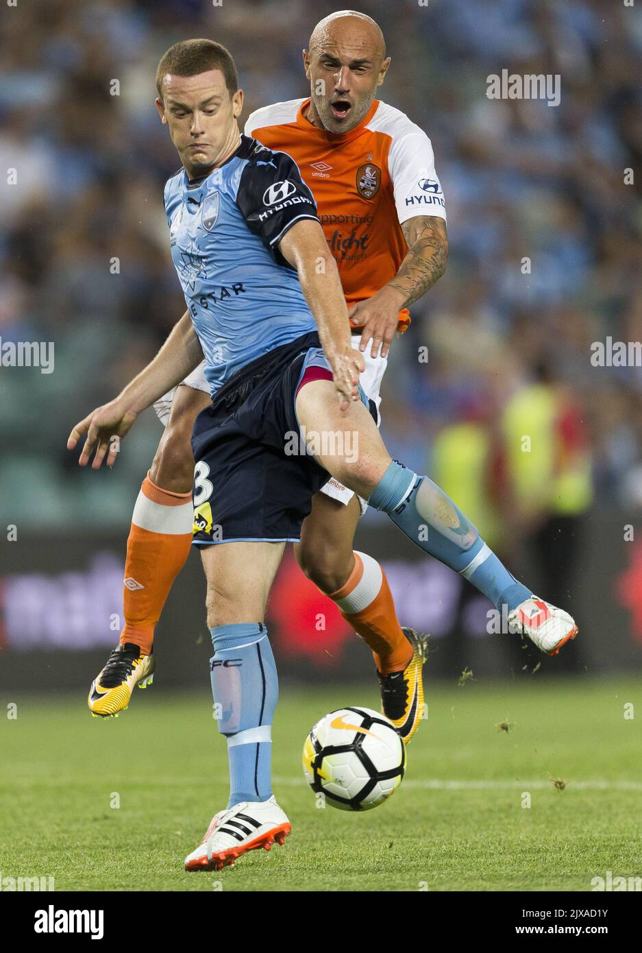 Massimo Maccarone of Brisbane and Brandon O'Neill of Sydney contest a ...