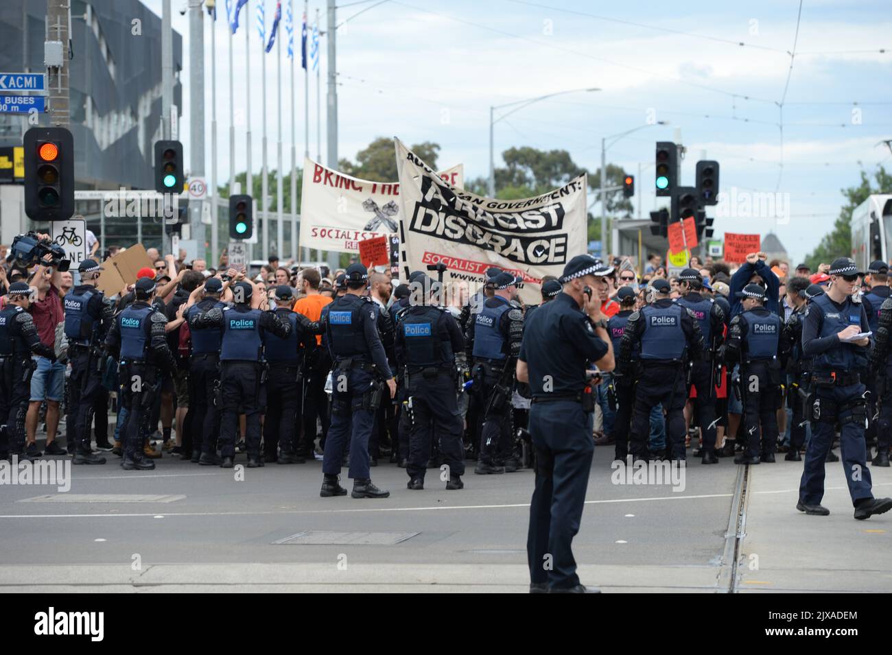Victoria Police officers are seen during a Manus Island protest in ...