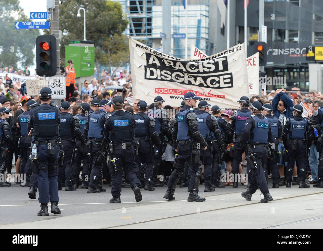 Victoria Police officers are seen during a Manus Island protest in ...