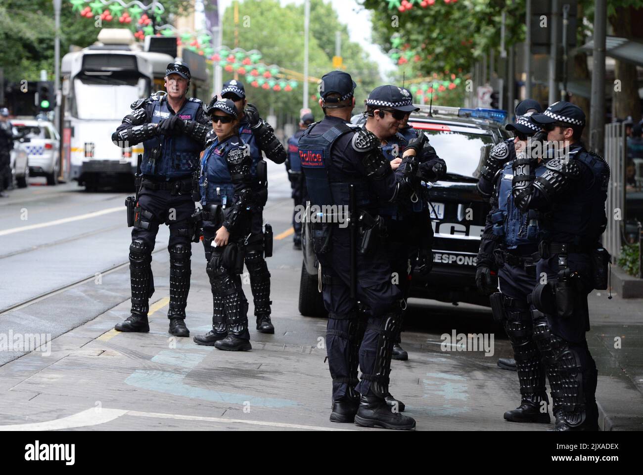 Victoria Police officers are seen during a Manus Island protest in ...