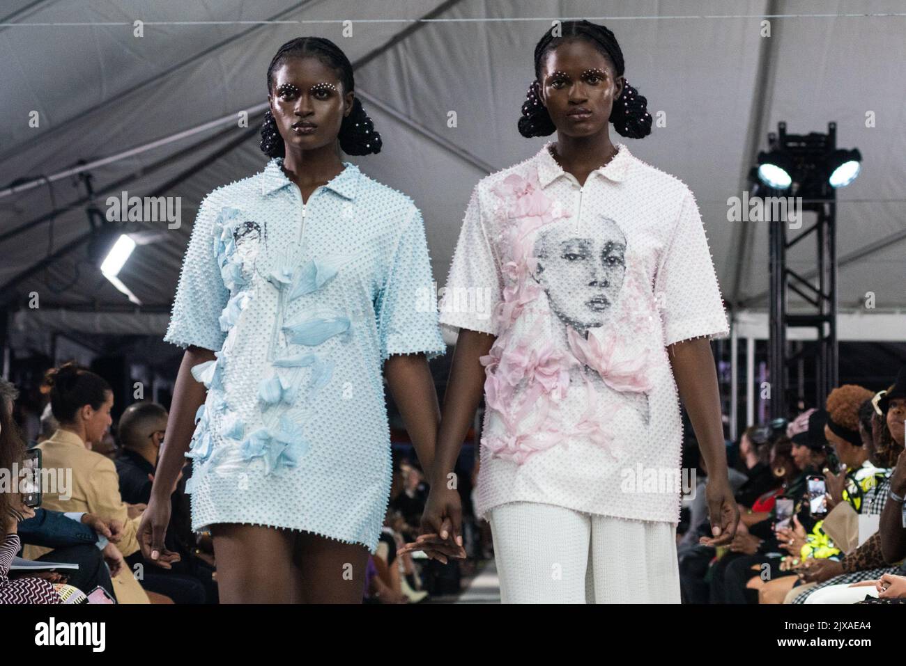 Two models walk runway during hi-res stock photography and images - Alamy