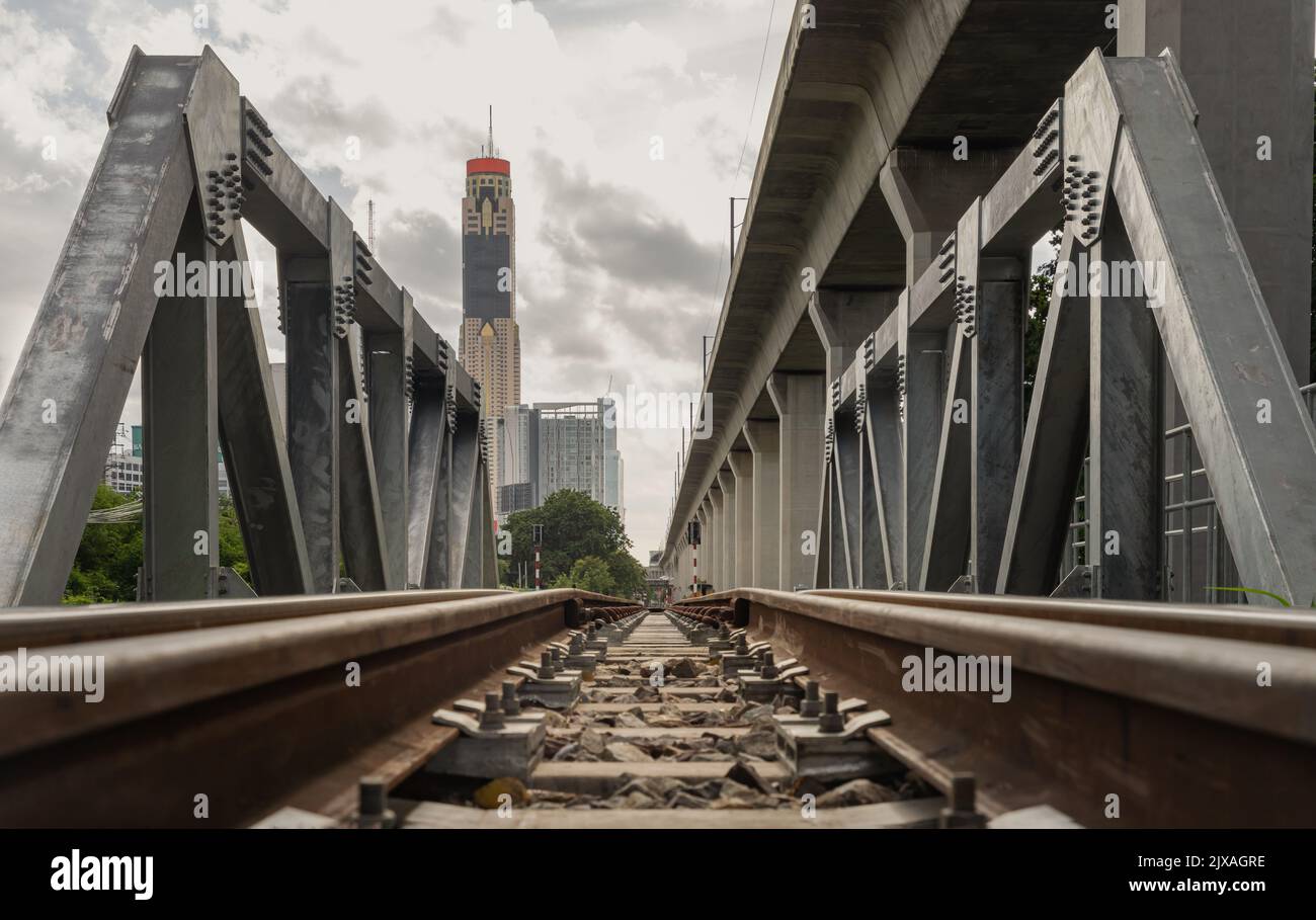 Old railroad train tracks on Bridge over the canal. Perspective of ...