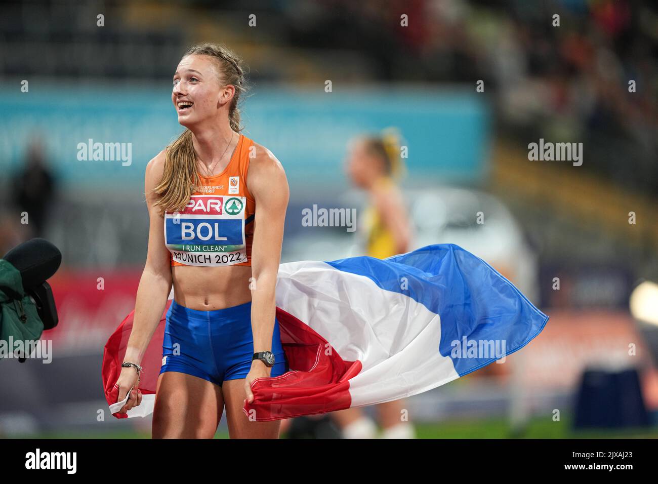 Femke Bol with her country's flag as the winner of the 400 meters ...