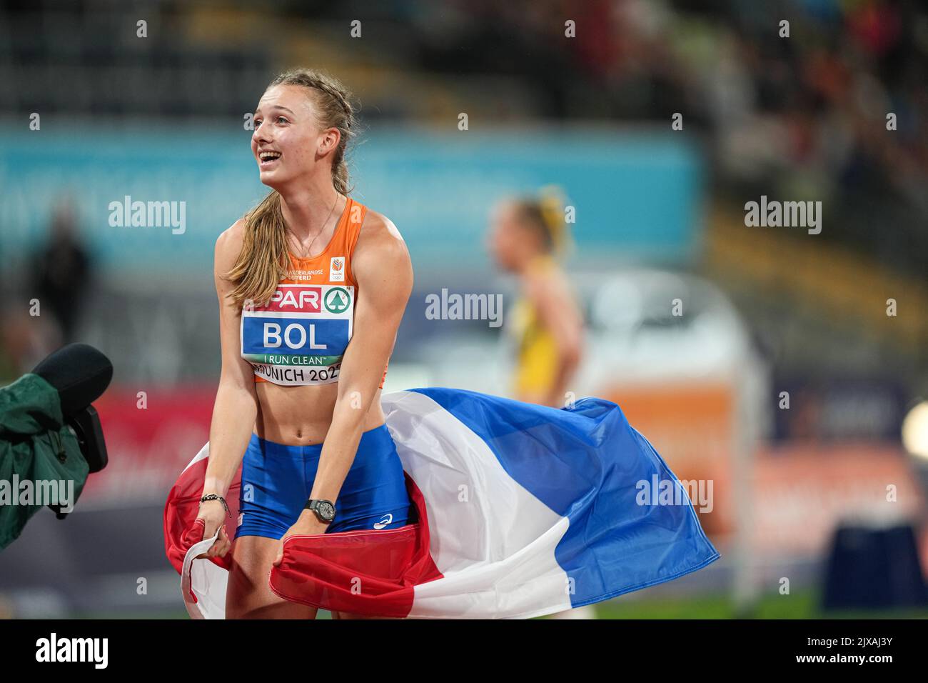 Femke Bol with her country's flag as the winner of the 400 meters ...