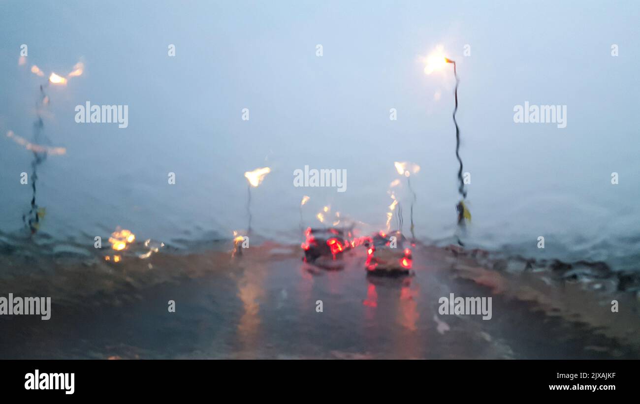 Inside the car. Closeup rain water drops. car windshield view during ...