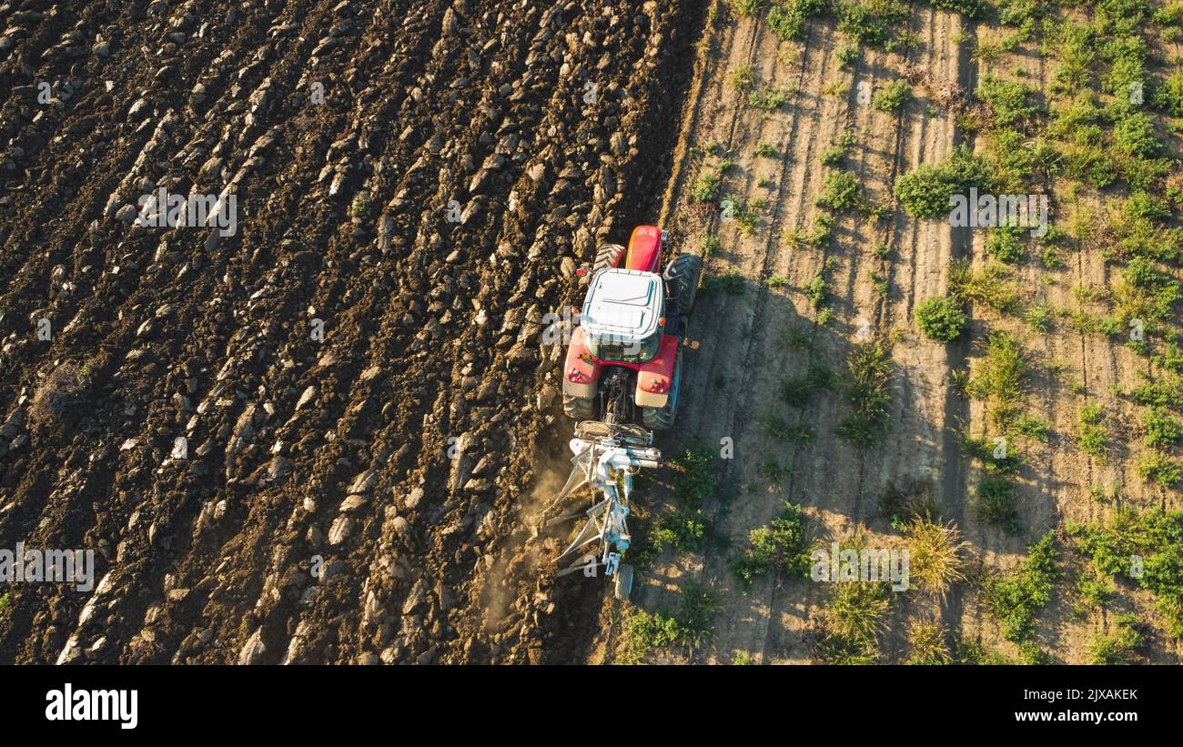Aerial view with drone of tractor plowing the land in the countryside ...