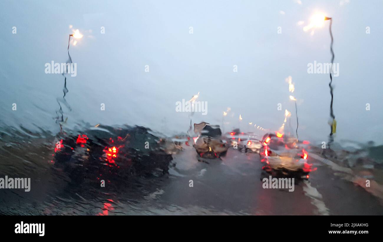 Inside the car. Closeup rain water drops. car windshield view during ...