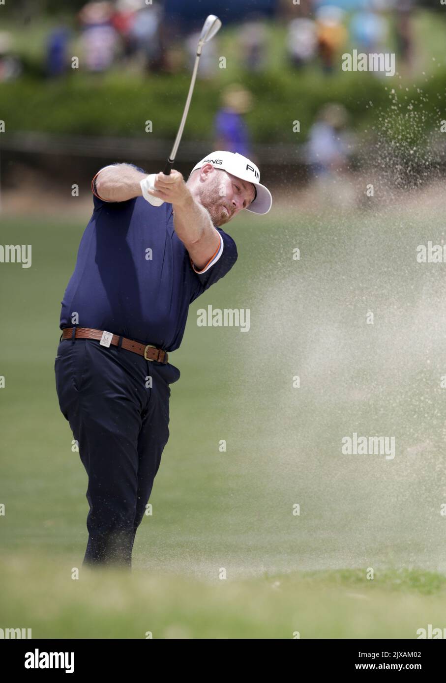 Adam Bland plays from the sand on the fourth hole in today's third ...