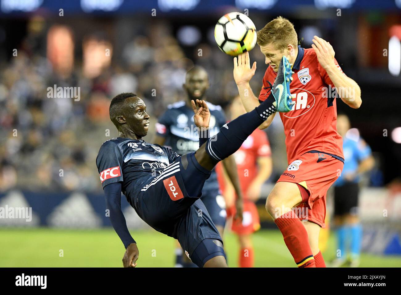 Thomas Deng of Victory and Ryan Kitto of Adelaide contests for the ball ...