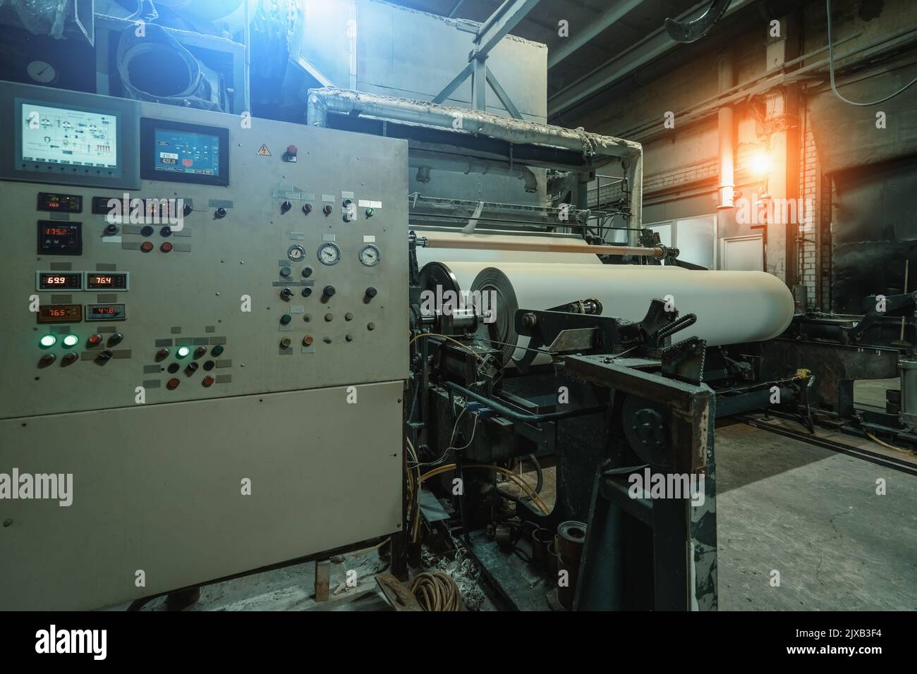 Paper production machine in wastepaper recycling factory. Paper and ...