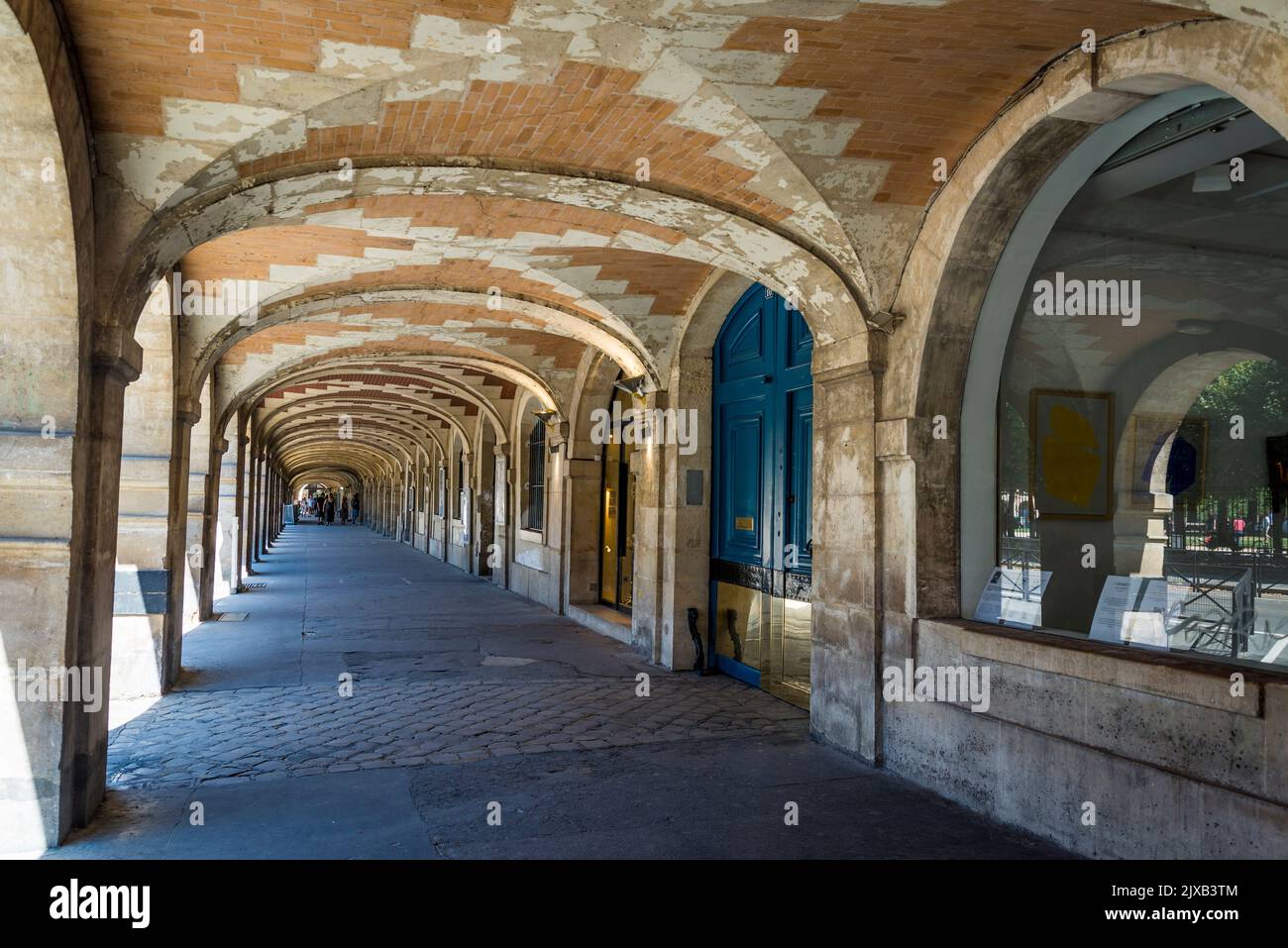 Arcades of the Place des Vosges, the oldest planned square in Paris ...