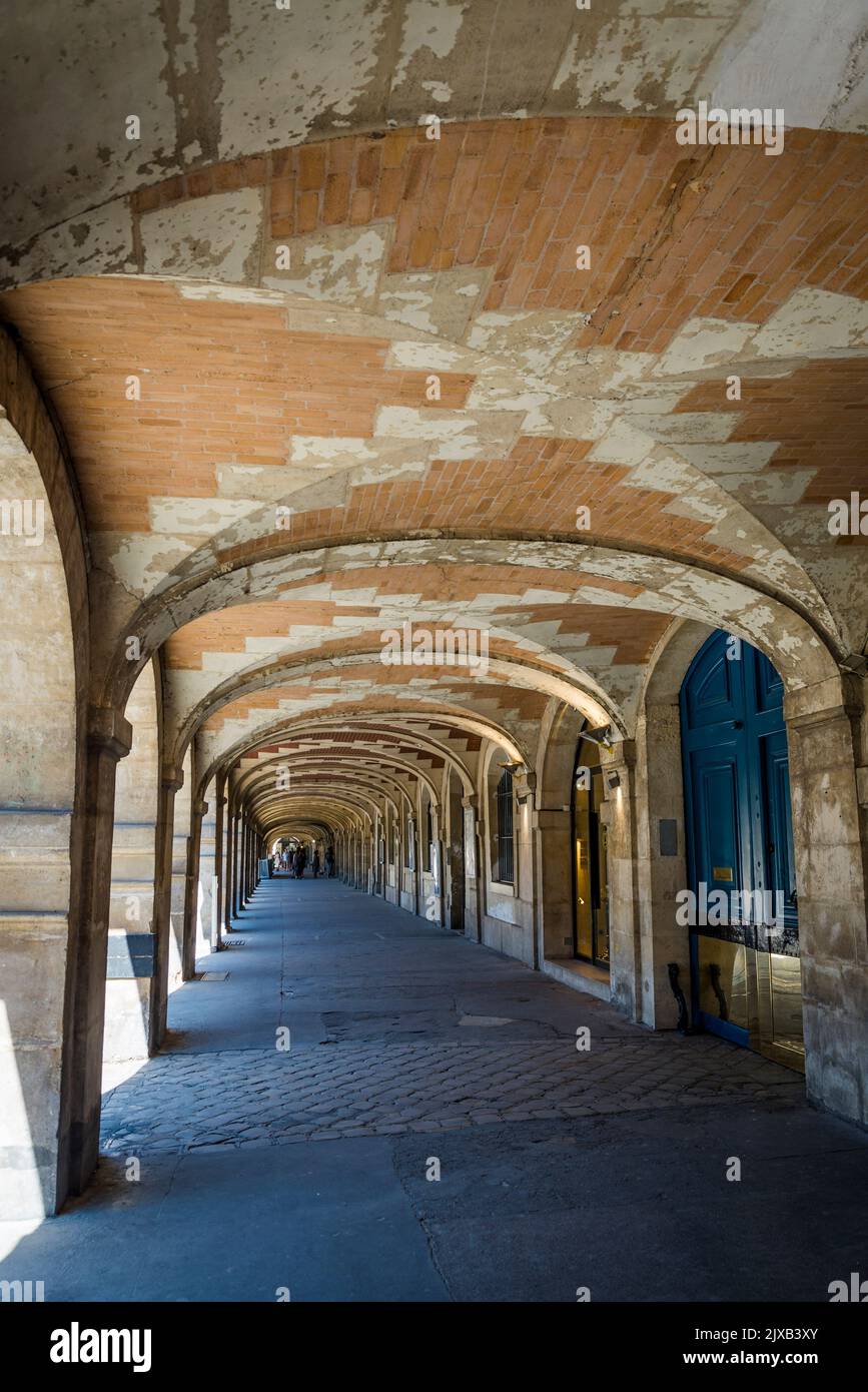 Arcades of the Place des Vosges, the oldest planned square in Paris ...