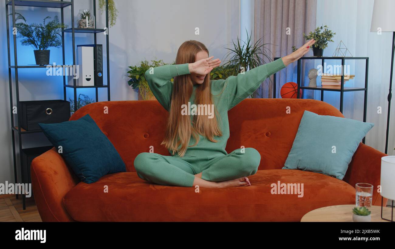 Trendy cheerful positive teen girl having fun dancing, moving to rhythm ...