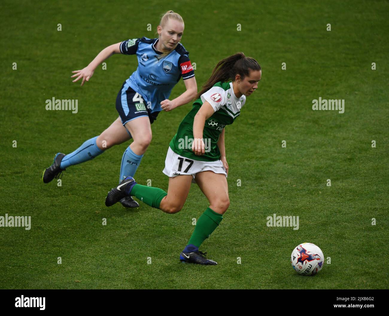Maddy Whittall of Canberra runs with the ball as Elizabeth Ralston of ...