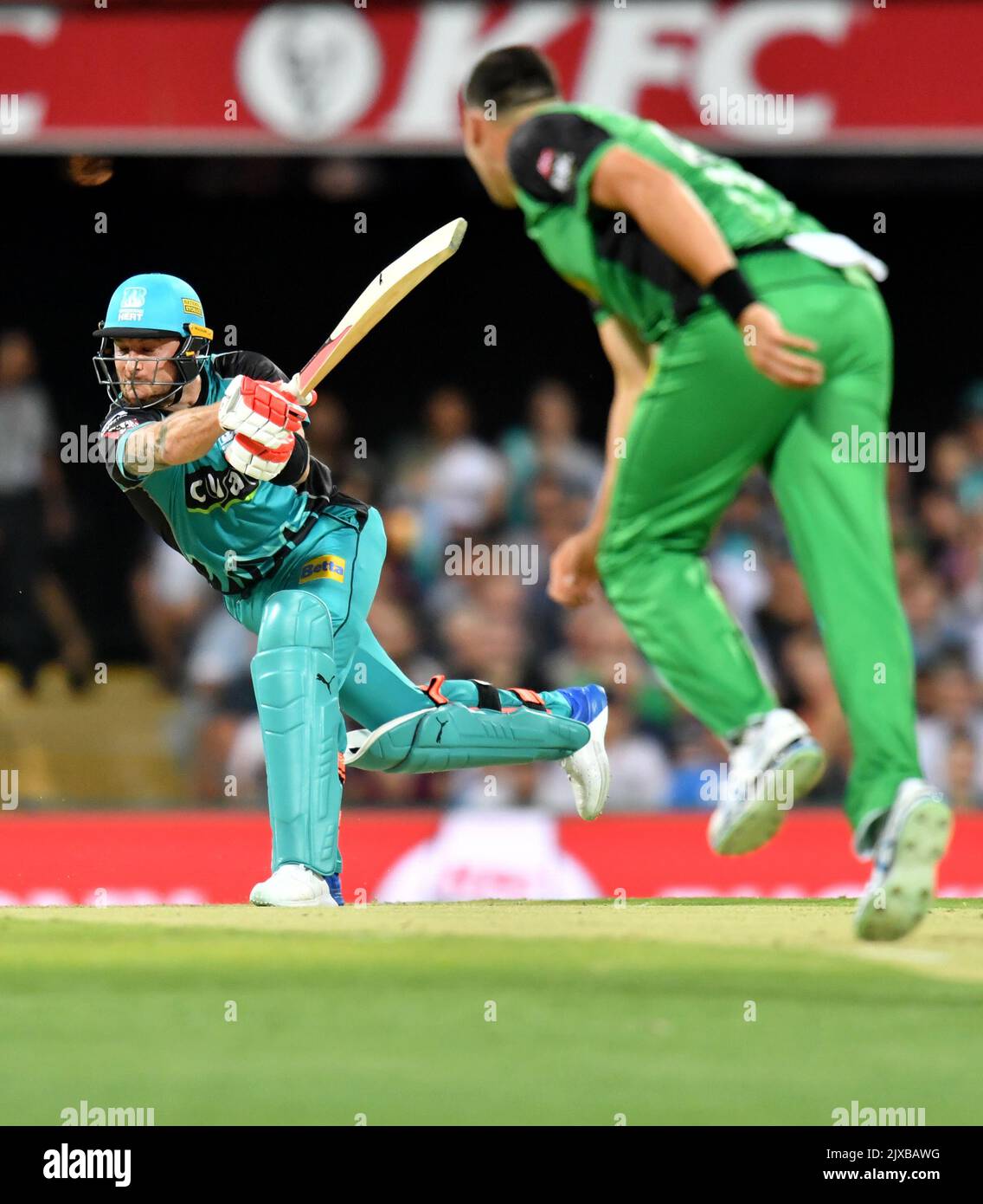 Brendon McCullum (left) of the Heat hits four runs off the bowling of ...