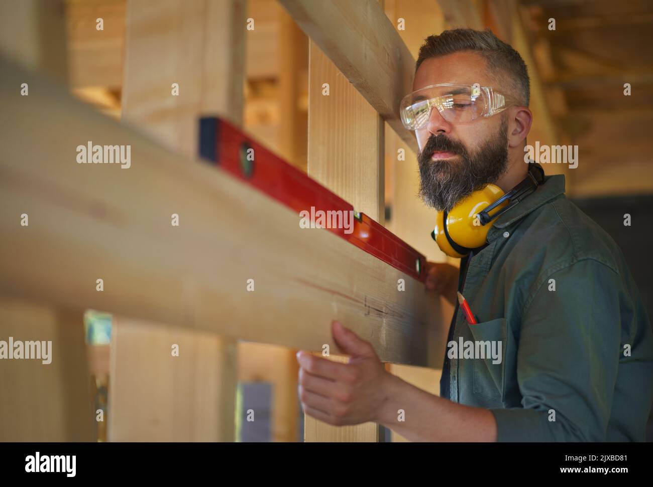 Carpenter checking wooden planks with spirit level, diy eco-friendly ...