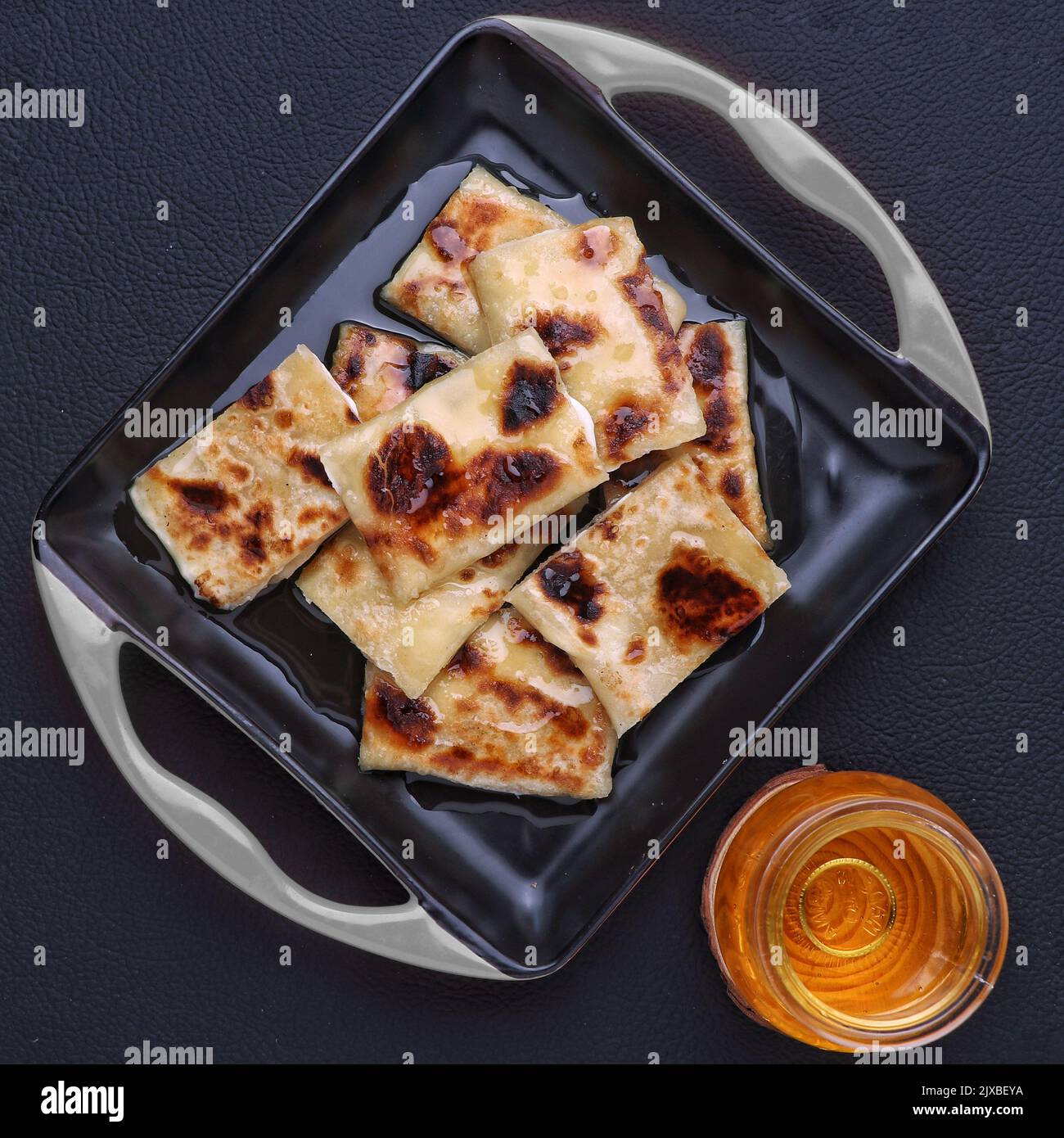 roasted tandoori roti with chocolate arrange in a dish dark background ...