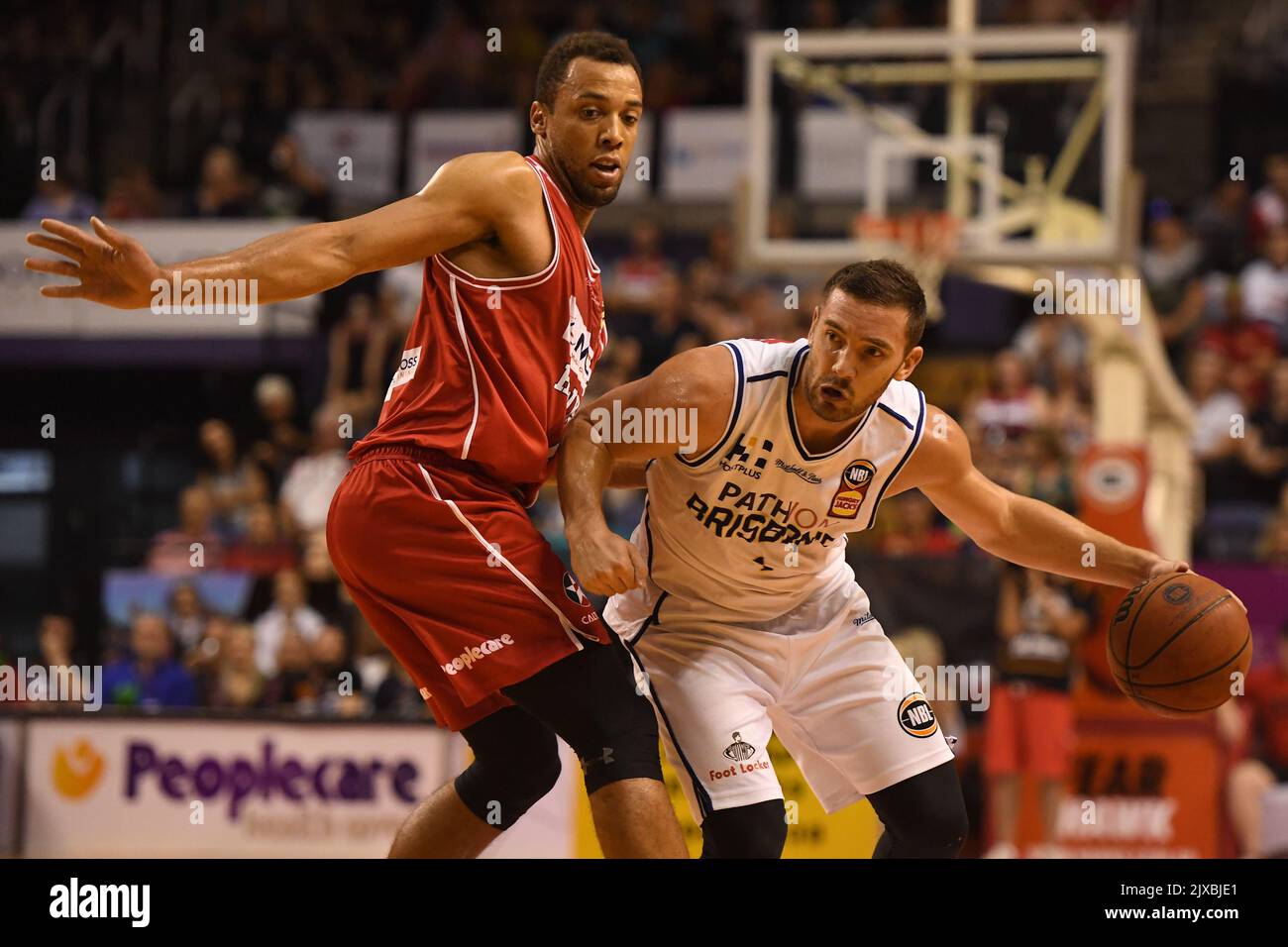 Demitrius Conger of the Hawks applies pressure to Adam Gibson of the ...
