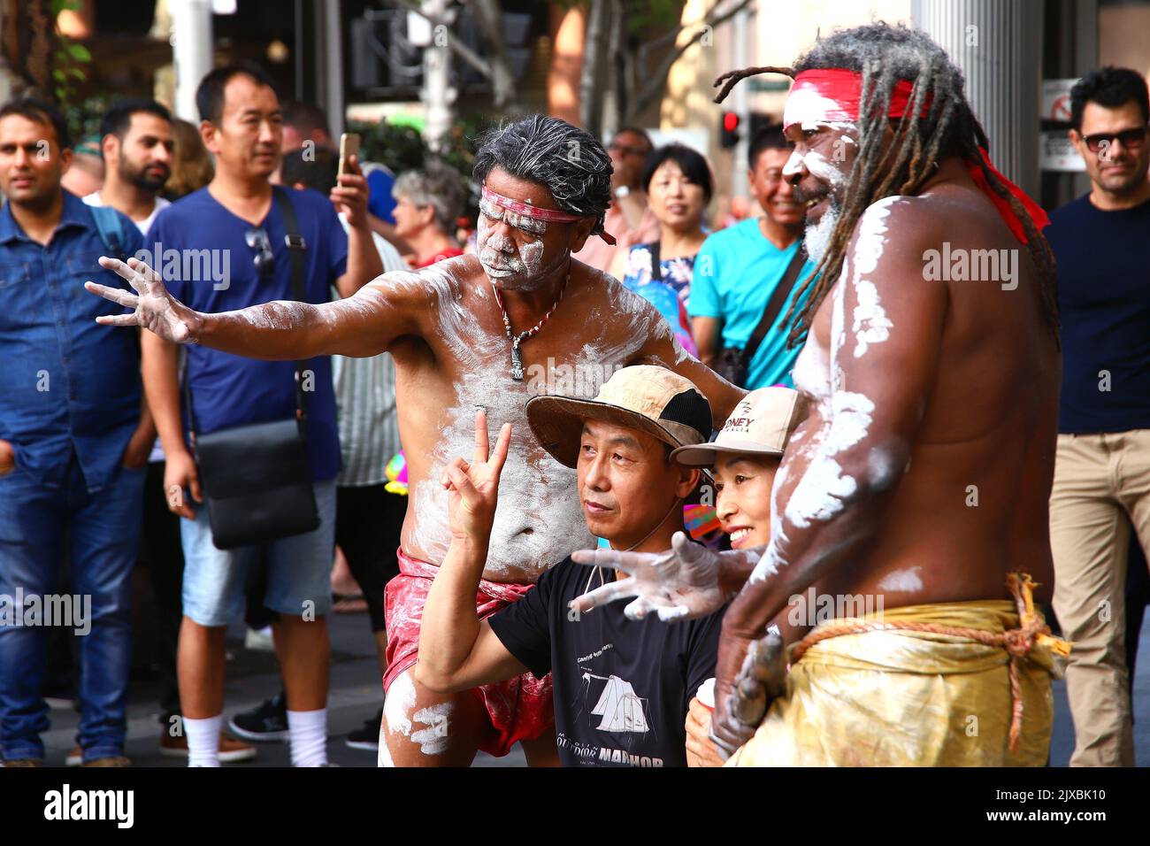 A couple pose with performers at Circular Quay ahead of the New Year's ...