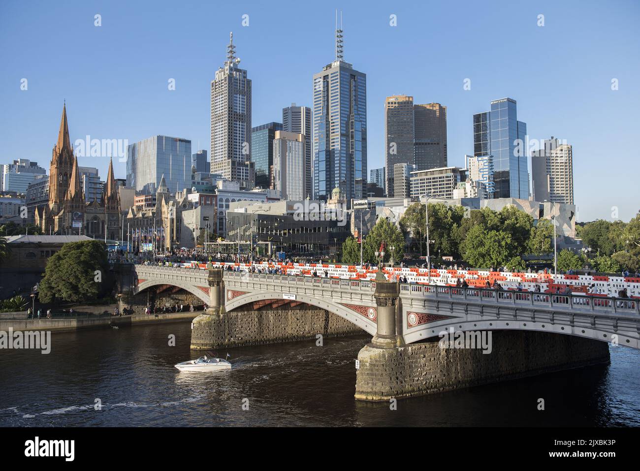 People walk between the orange and white security barriers on Princess ...