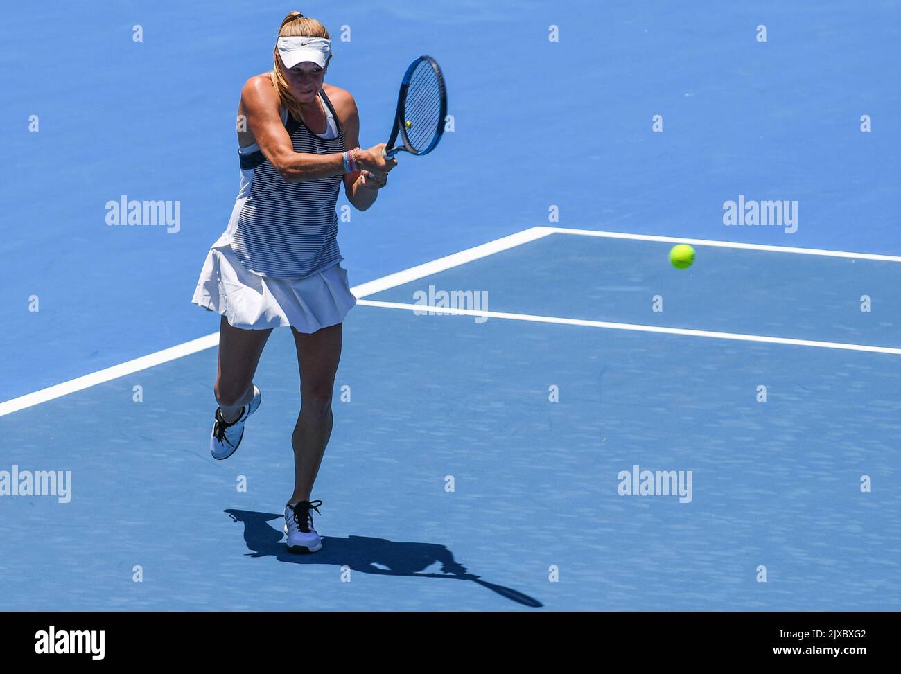 Ellen Perez of Australia hits the ball against Kristina Mladenovic of ...