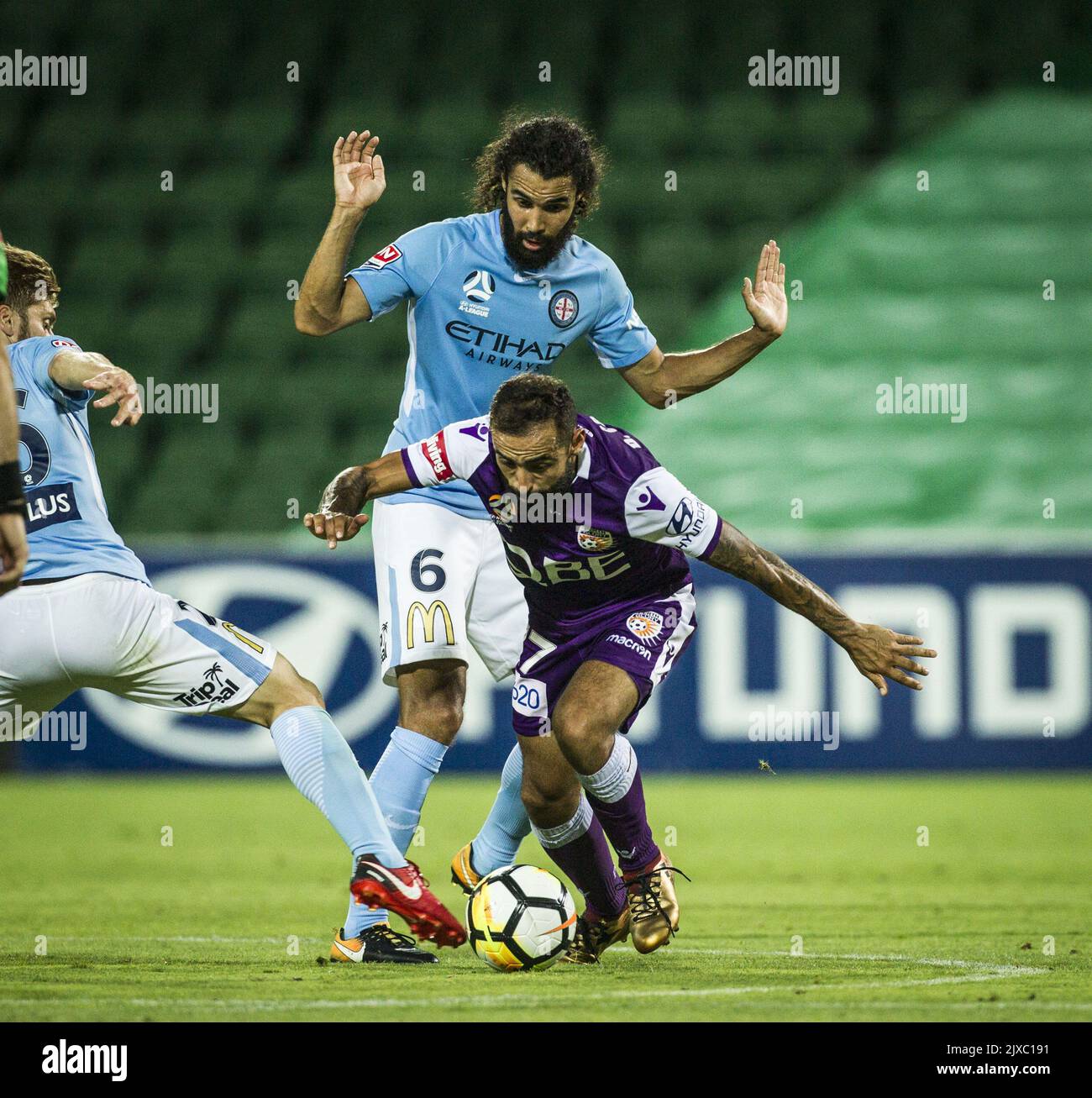 Diego Castro of the Perth Glory and Osama Malik for Melbourne City ...