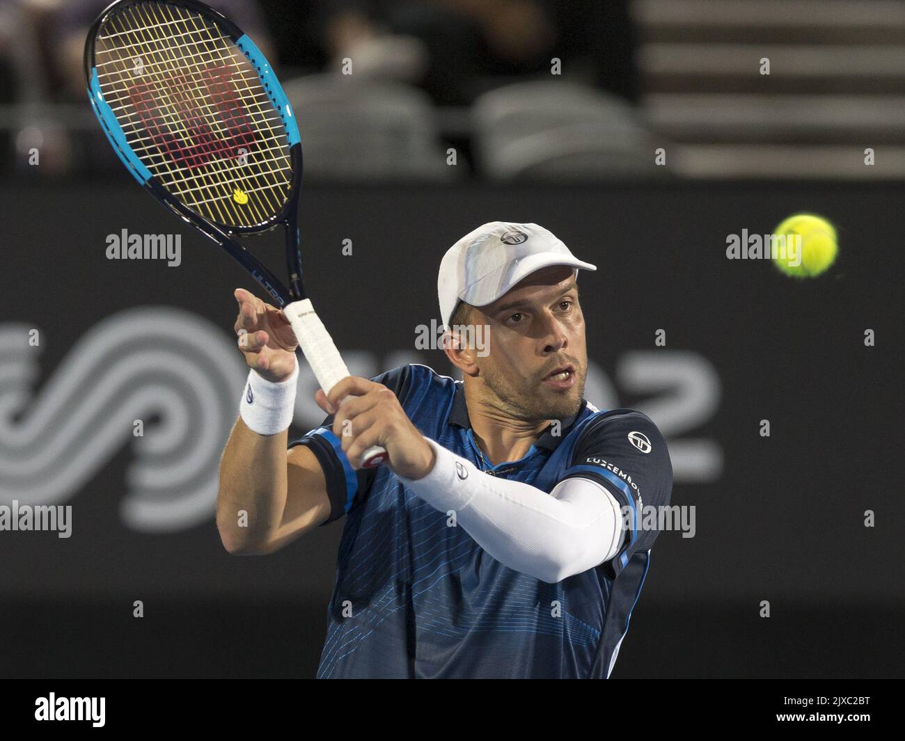 Gilles Muller of Luxembourg plays a backhand to John Millman of ...