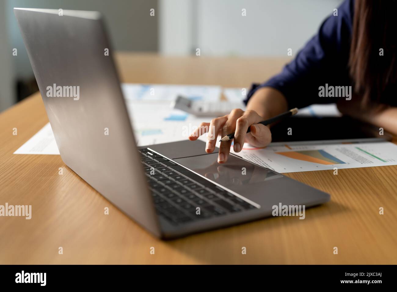 Close up woman using calculator and laptop, reading documents, young ...