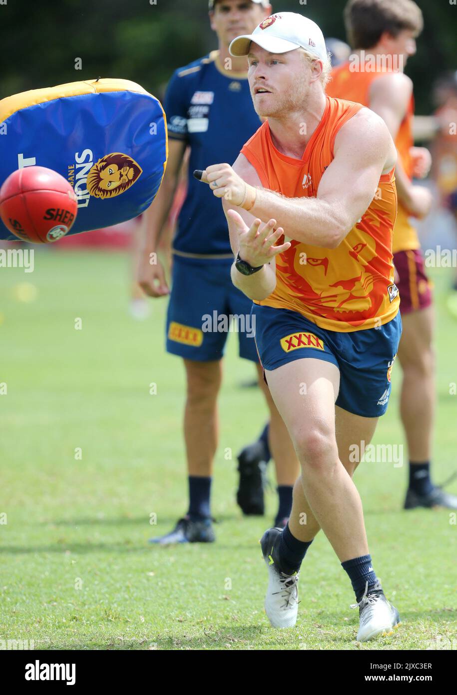 Daniel Rich passes the ball during a Brisbane Lions training session at ...
