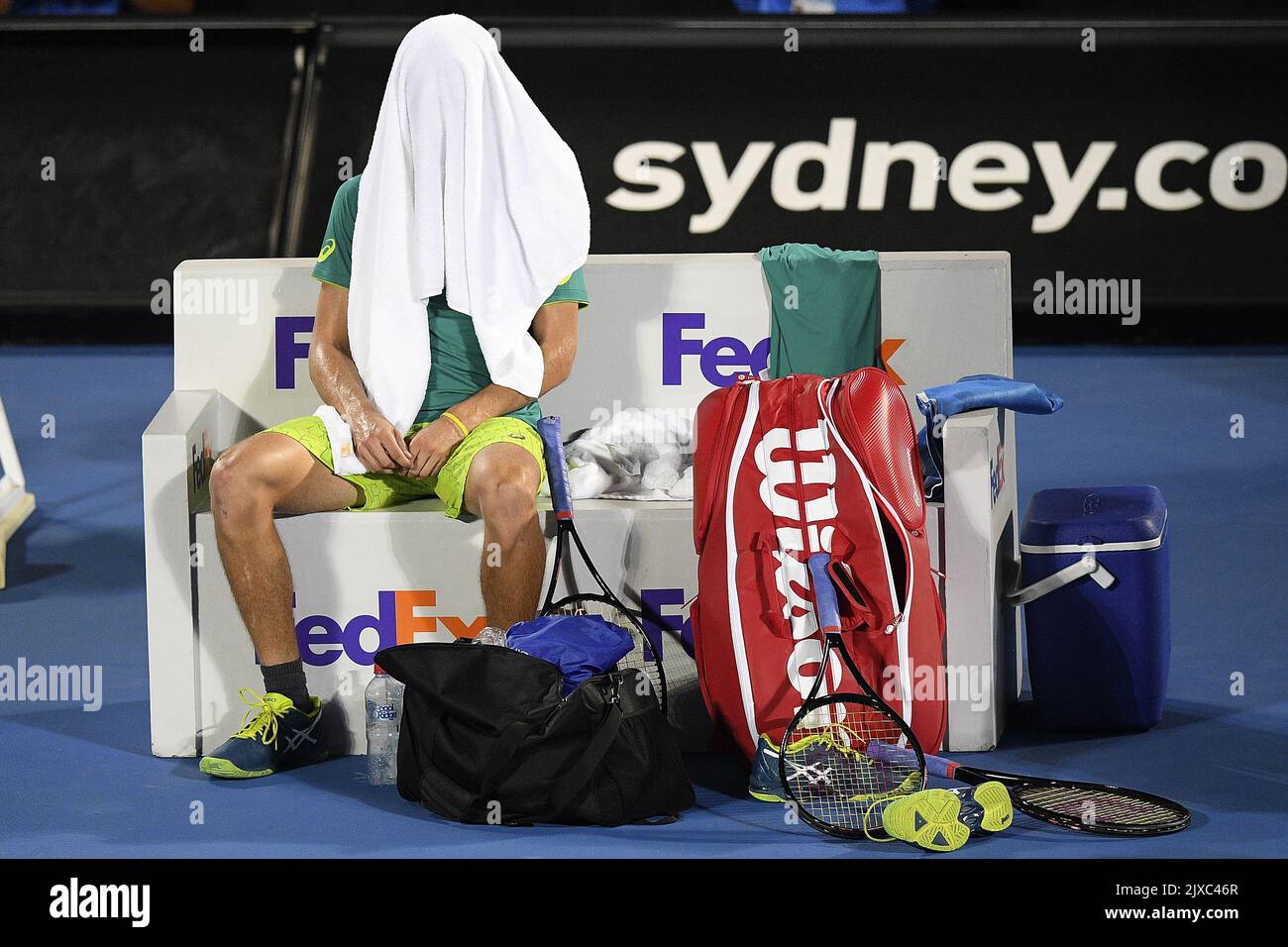 Alex de Minaur of Australia sits during a break in play of his semi ...