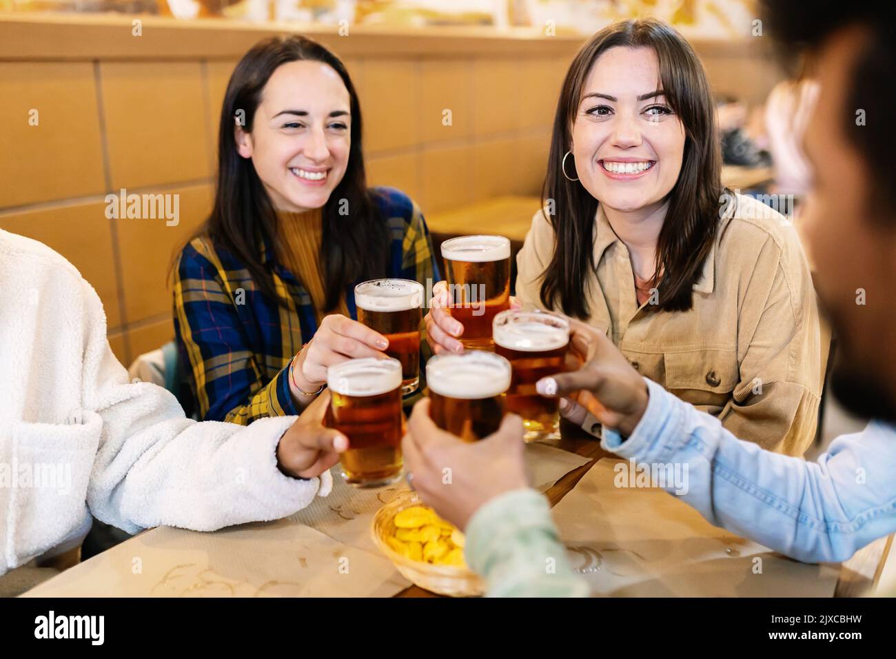 Group of happy young friends enjoying drinks at brewery pub bar Stock ...