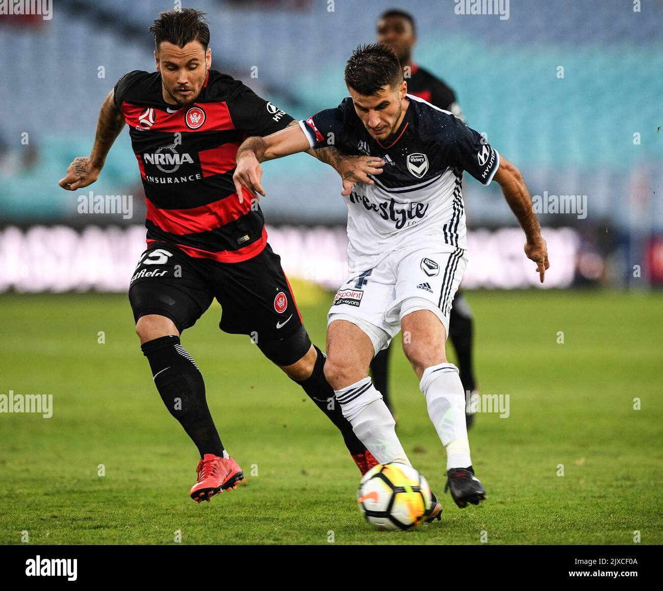 Terry Antonis (right) for the Victory contests possession against ...
