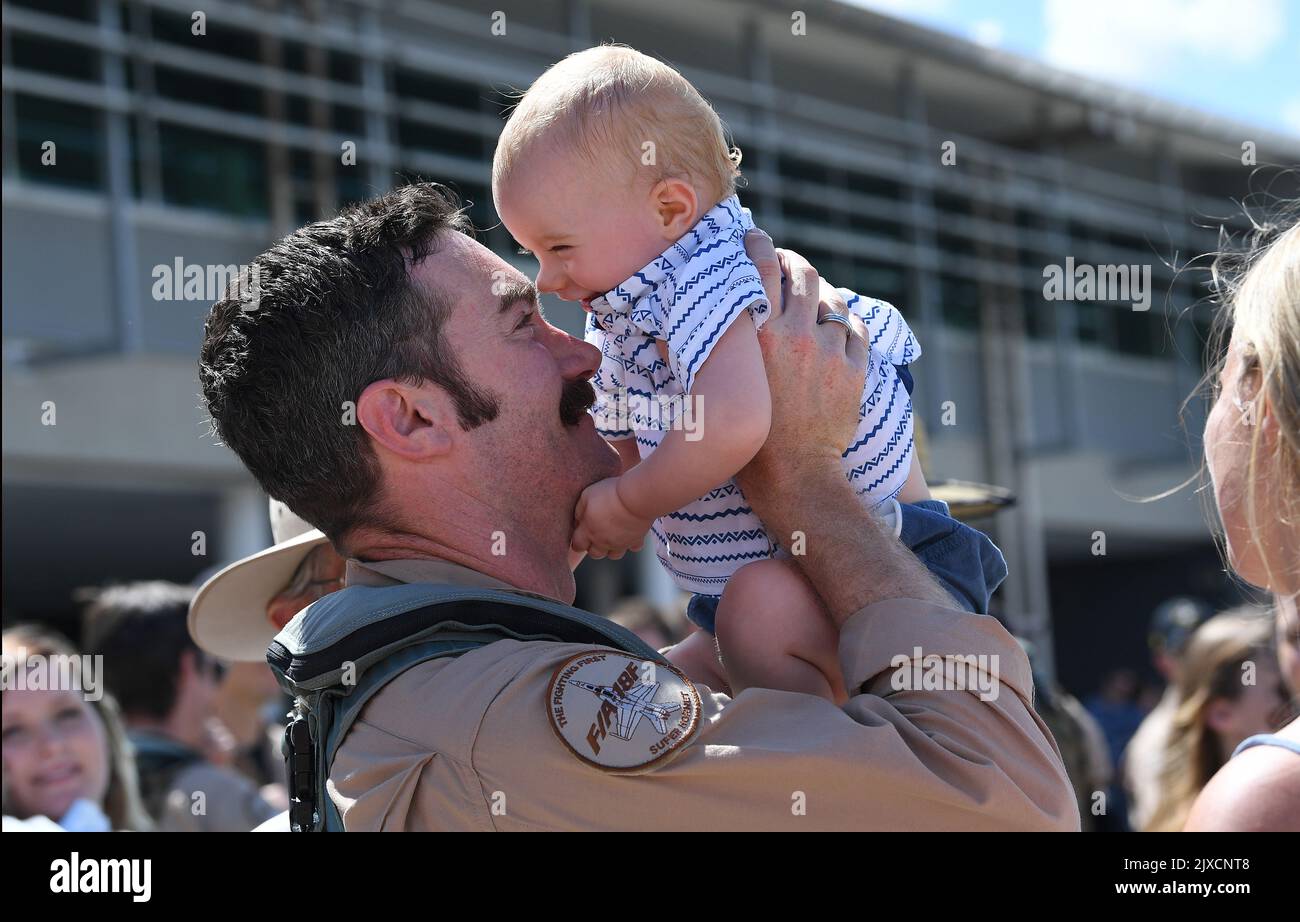 Grant (last name withheld), a pilot from RAAF No.1 Squadron, is greeted ...