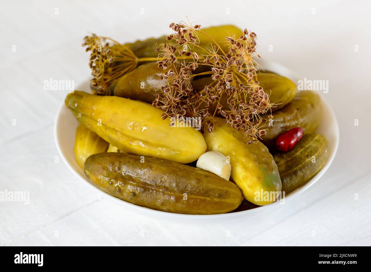 Healthy fermented food. Salt cucumbers in bowl with dill and peppers on ...